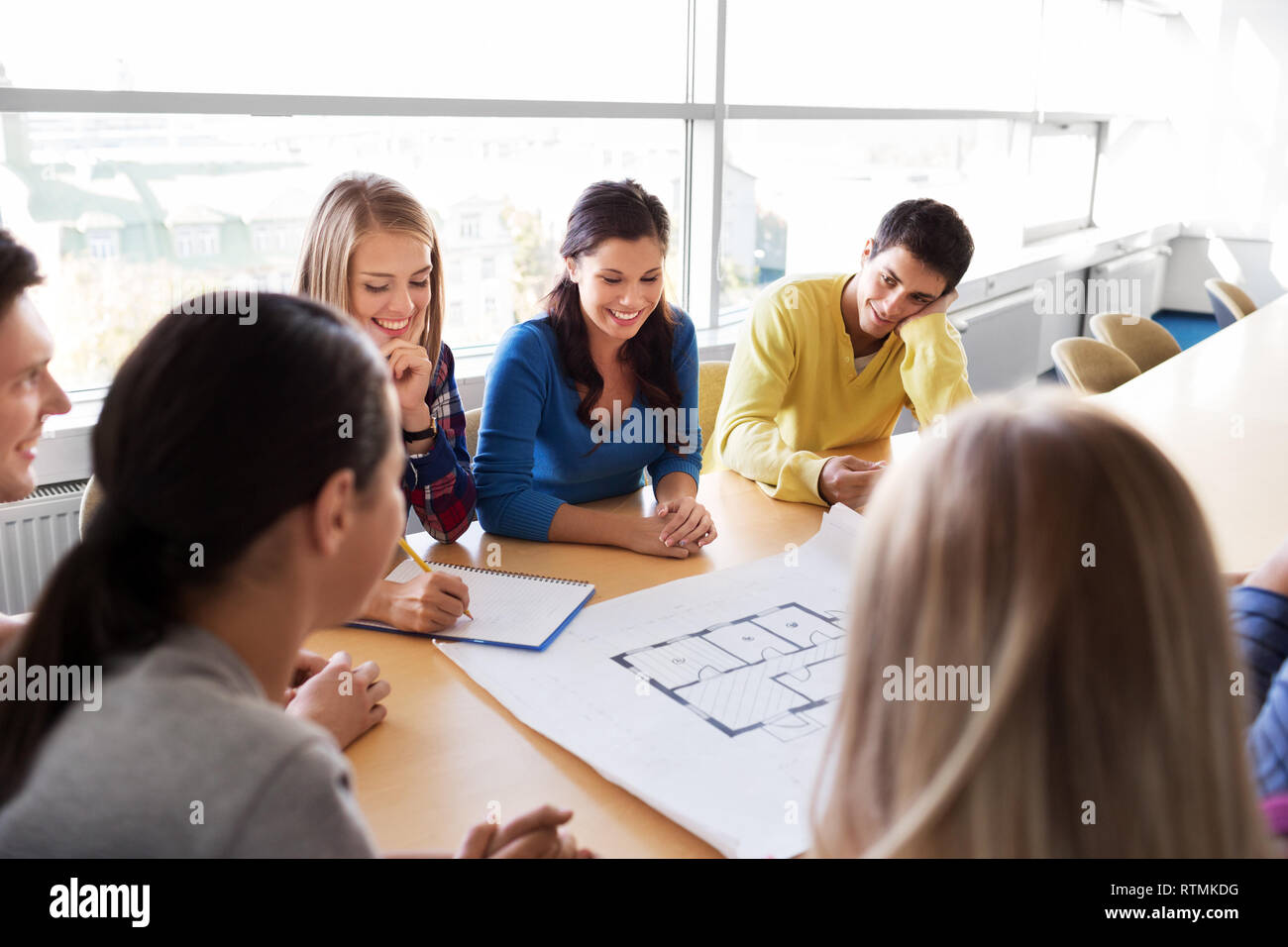 group of smiling students with blueprint Stock Photo - Alamy