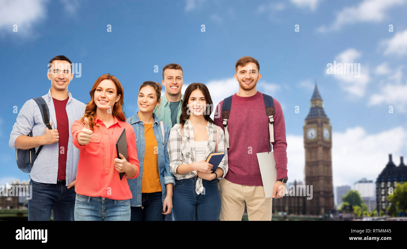 group of students showing thumbs up over london Stock Photo - Alamy