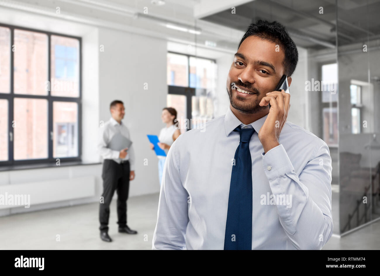 indian businessman calling on smartphone at office Stock Photo - Alamy