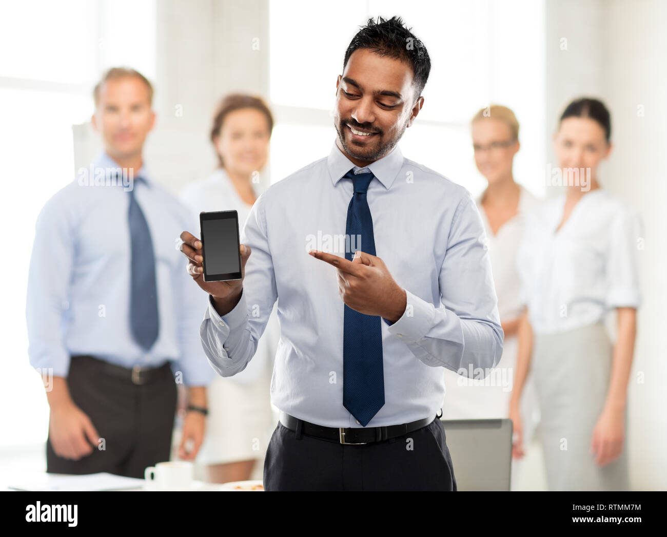 indian businessman showing smartphone at office Stock Photo - Alamy