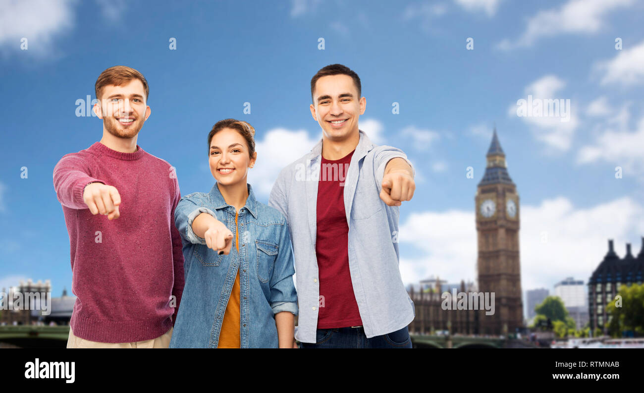 smiling friends pointing at you over london Stock Photo - Alamy