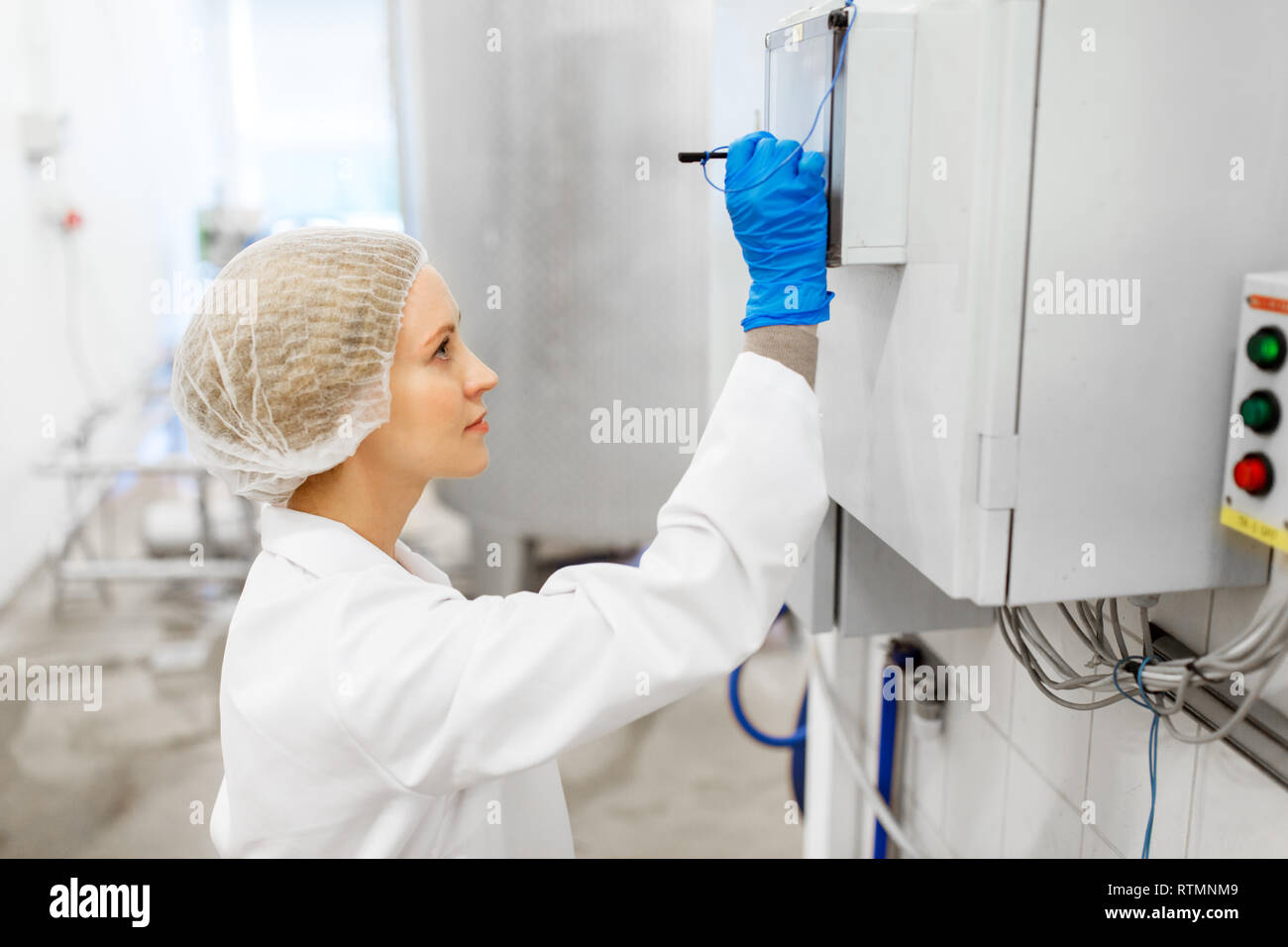 woman programming computer at ice cream factory Stock Photo - Alamy