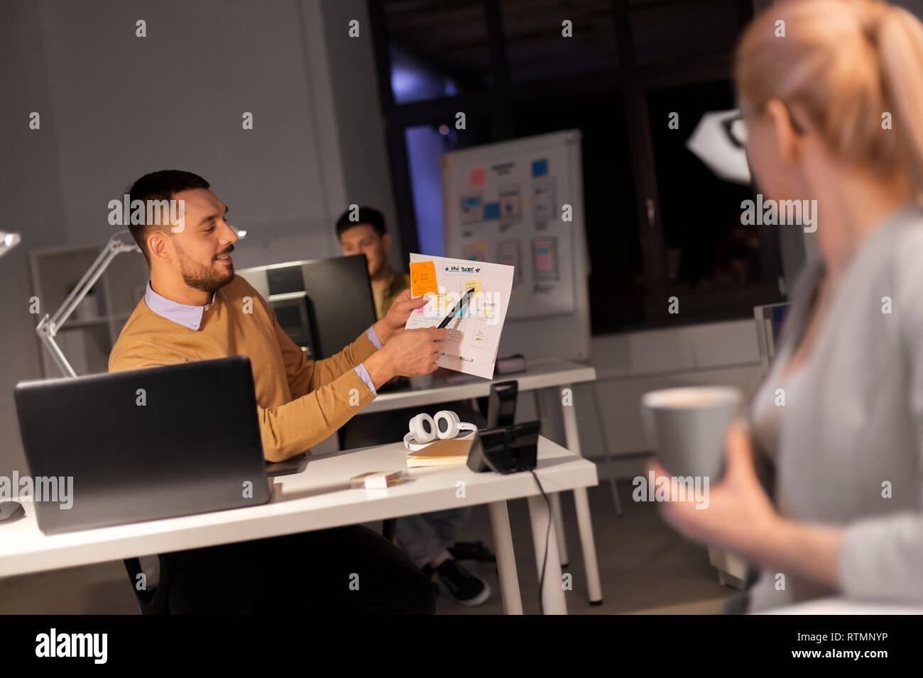 business team with papers working late at office Stock Photo - Alamy