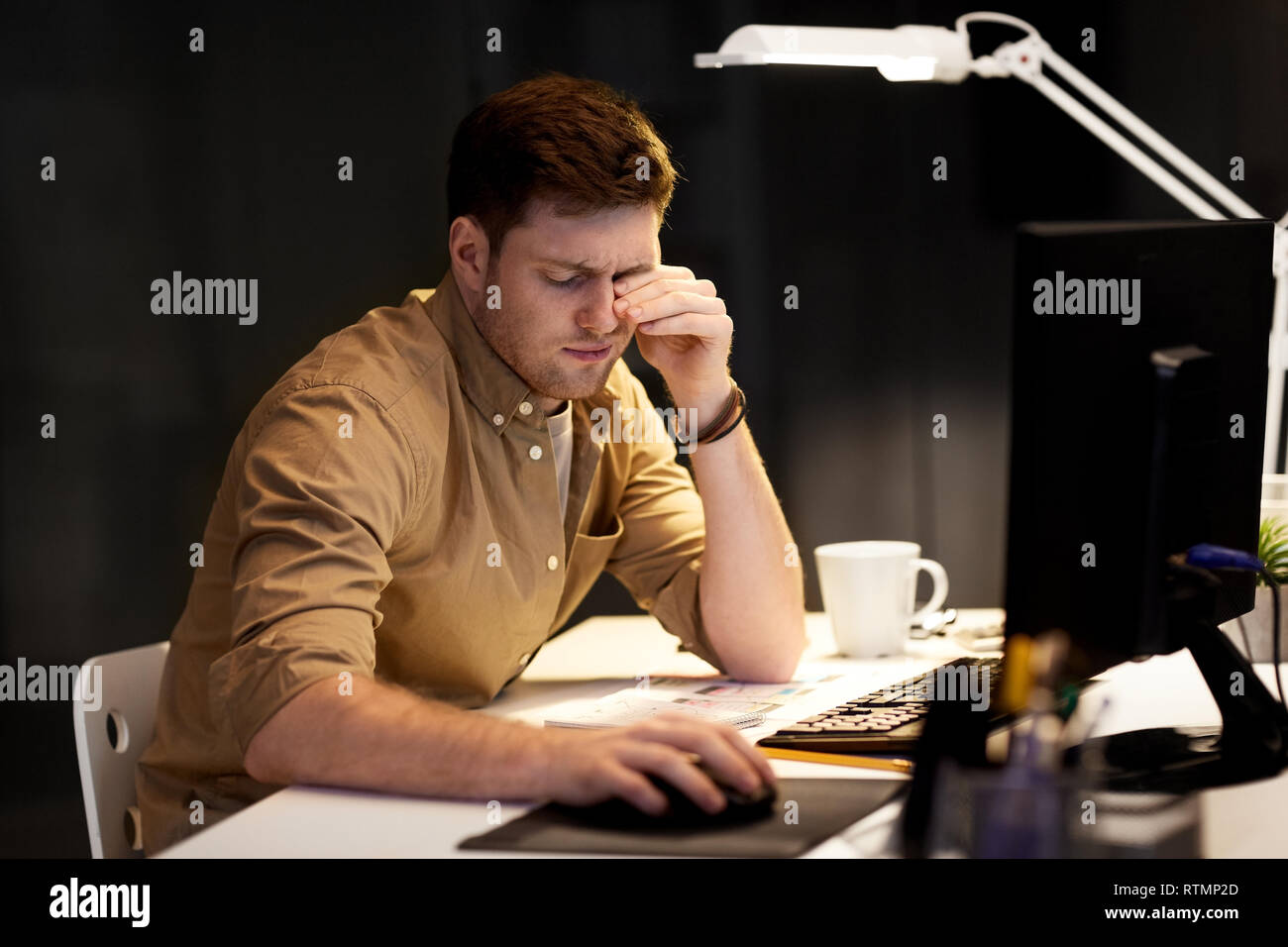 Tired businessman working late hi-res stock photography and images - Alamy
