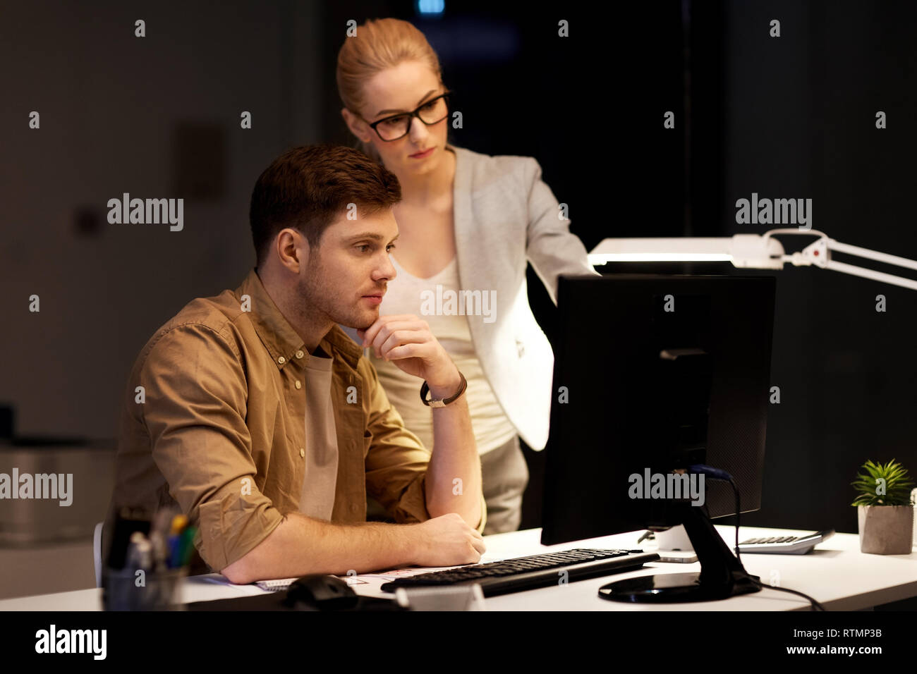 business team with computer working late at office Stock Photo - Alamy