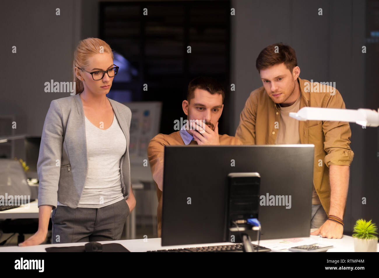 business team with computer working late at office Stock Photo - Alamy