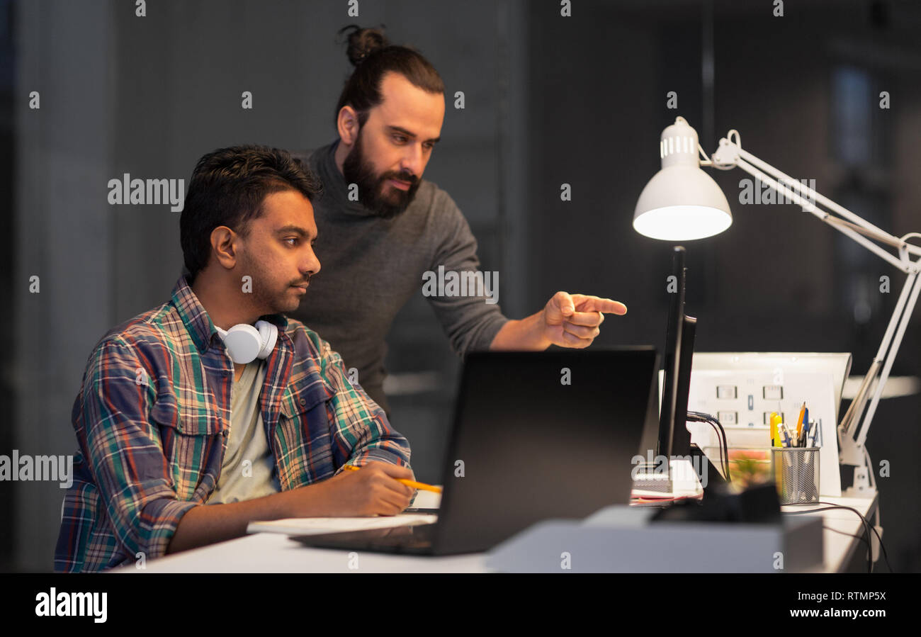creative team with computer working late at office Stock Photo - Alamy