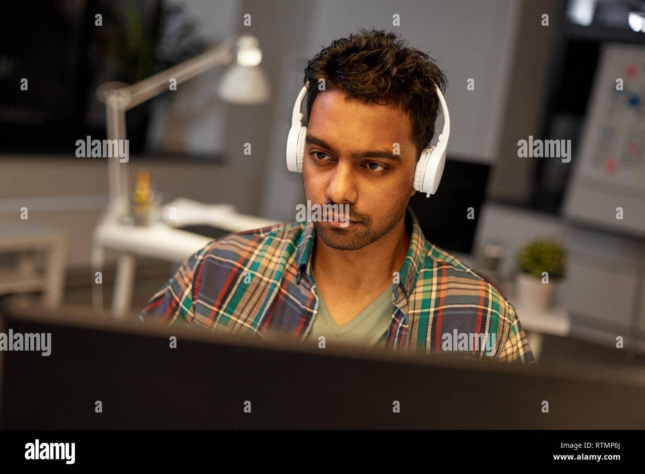 creative man with headphones working at office Stock Photo - Alamy