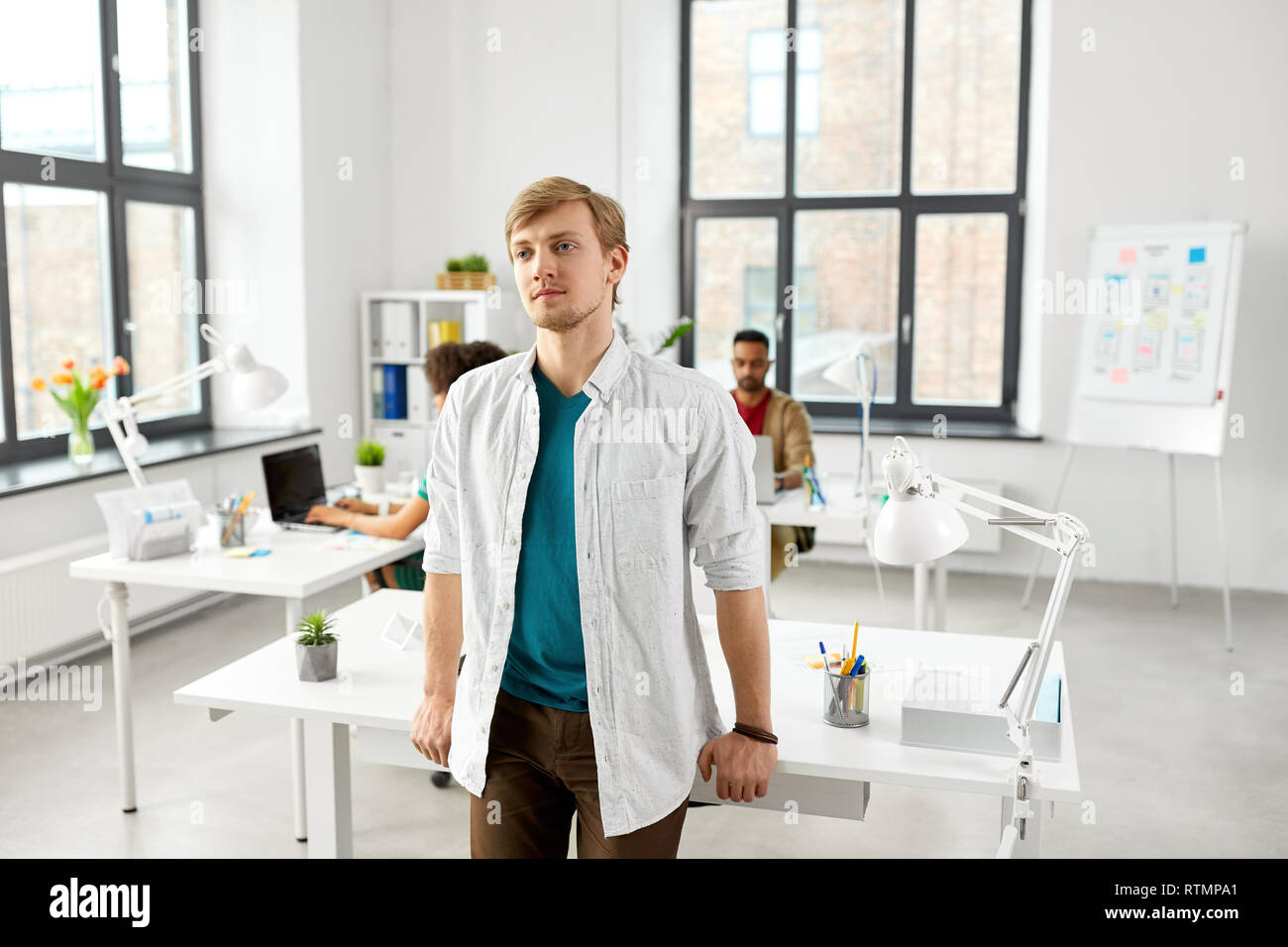 man standing at office table Stock Photo - Alamy