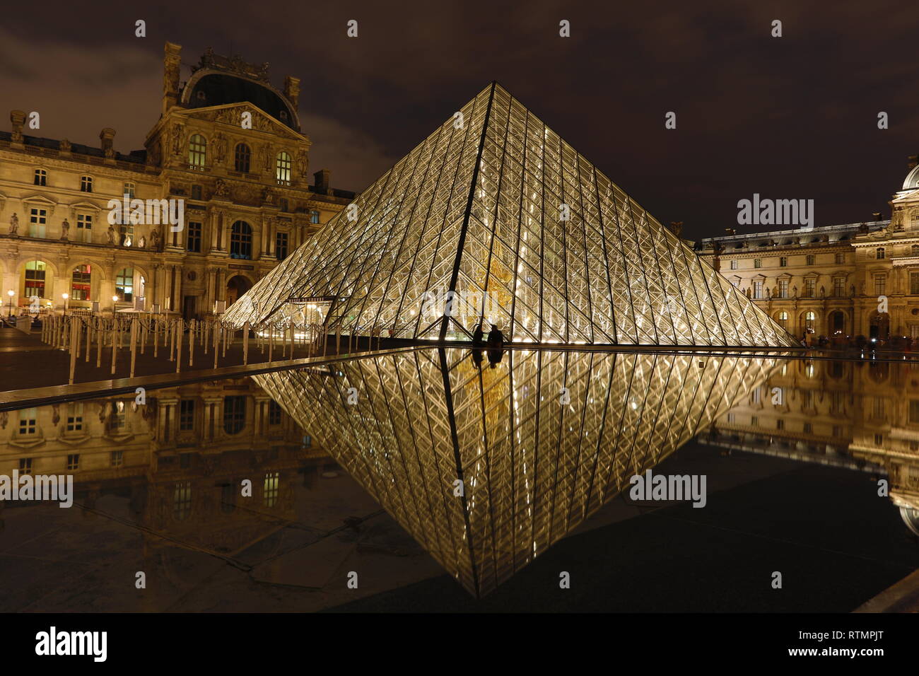 PARIS - OCTOBER 6, 2018 Louvre museum at twilight in summer. Louvre ...