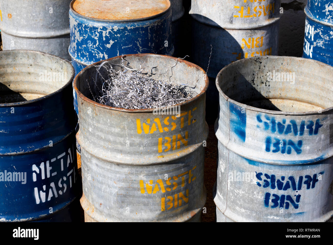 Metal waste bin storage area outside engineering works awaiting ...