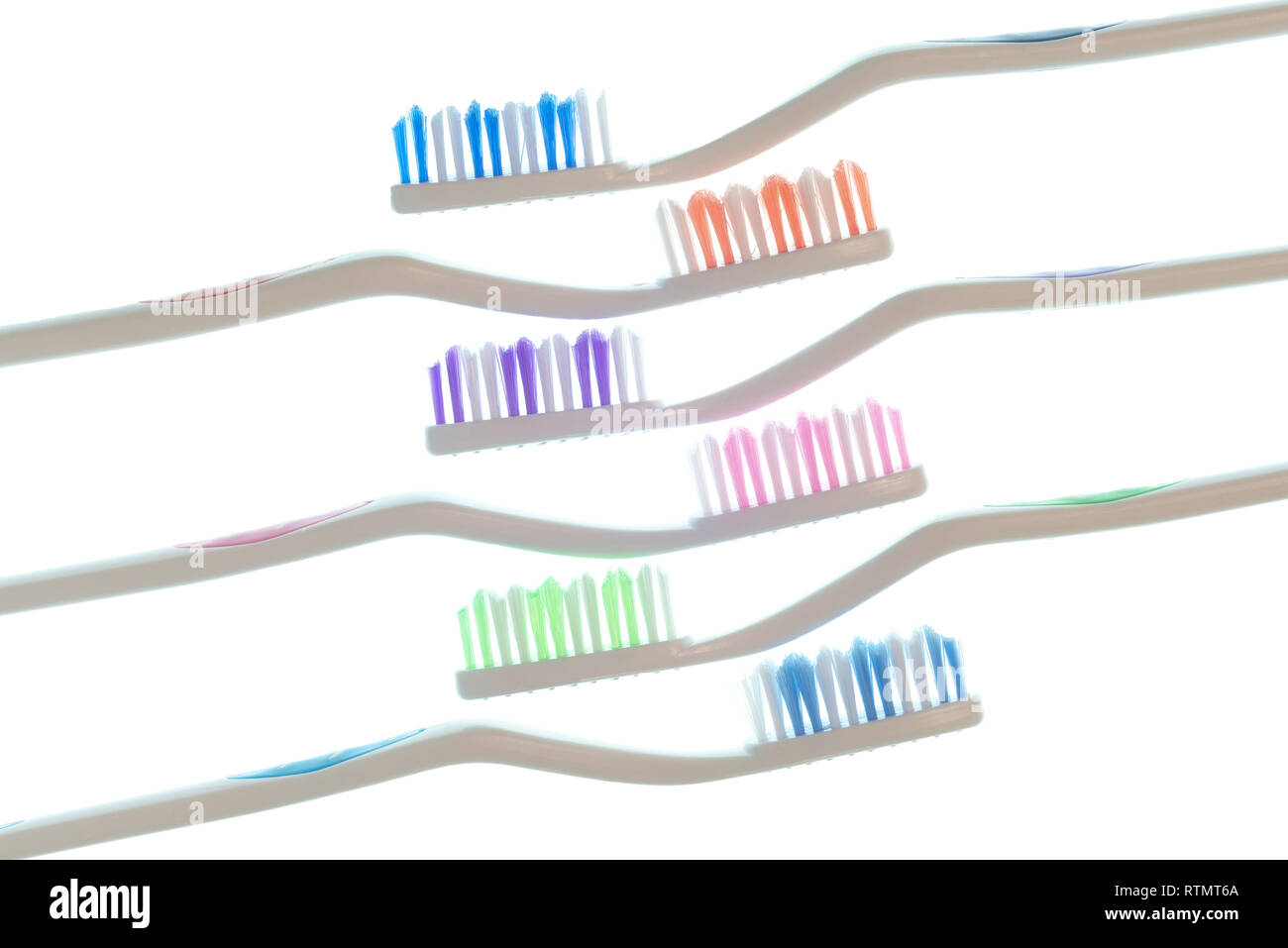 Horizontal side view shot of six colorful toothbrushes with white ...