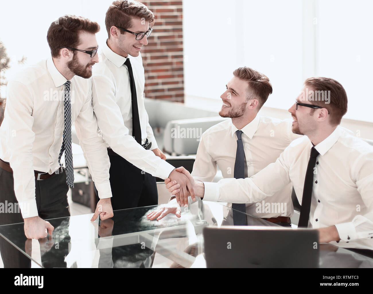 handshake colleagues in the workplace Stock Photo - Alamy