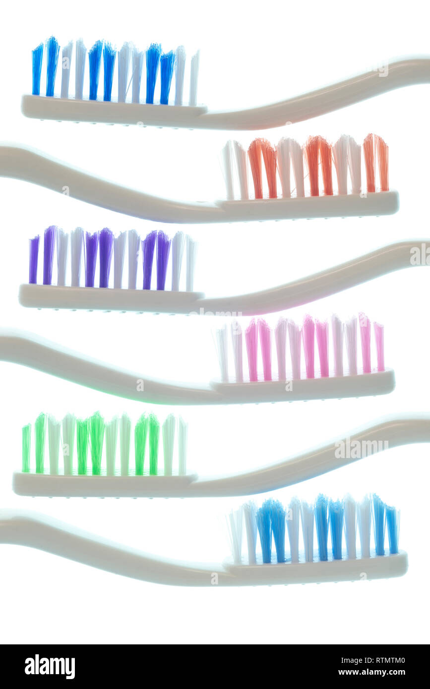 Vertical side view shot of a variety of colorful toothbrushes with ...