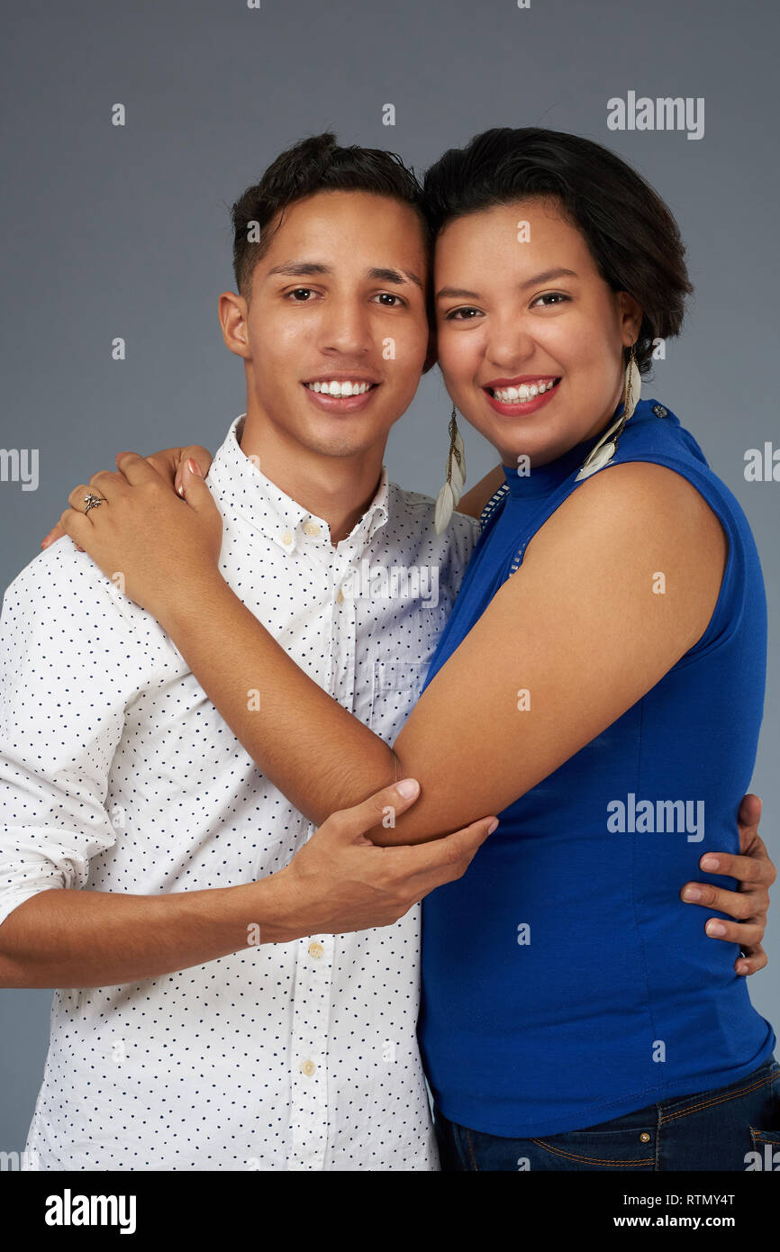 Portrait of young hispanic couple isolated on studio background Stock ...