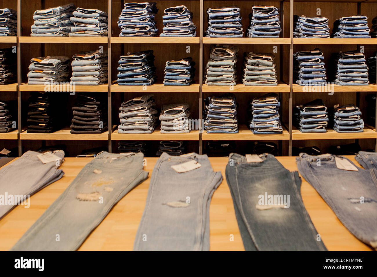Jeans pants on the store shelf. Blue jeans denim Collection jeans ...