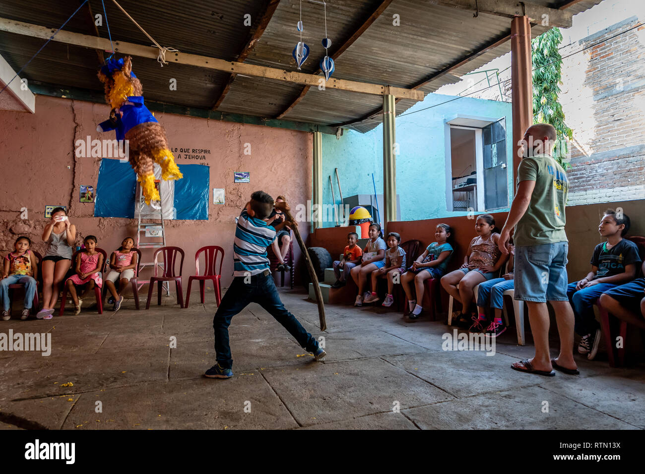 young latin boy swinging at pinata at Guatemalan birthday party Stock ...