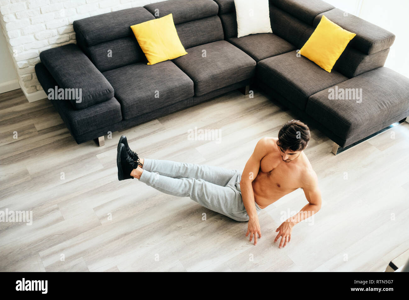 Fit young white man training at home. Handsome hispanic male athlete ...