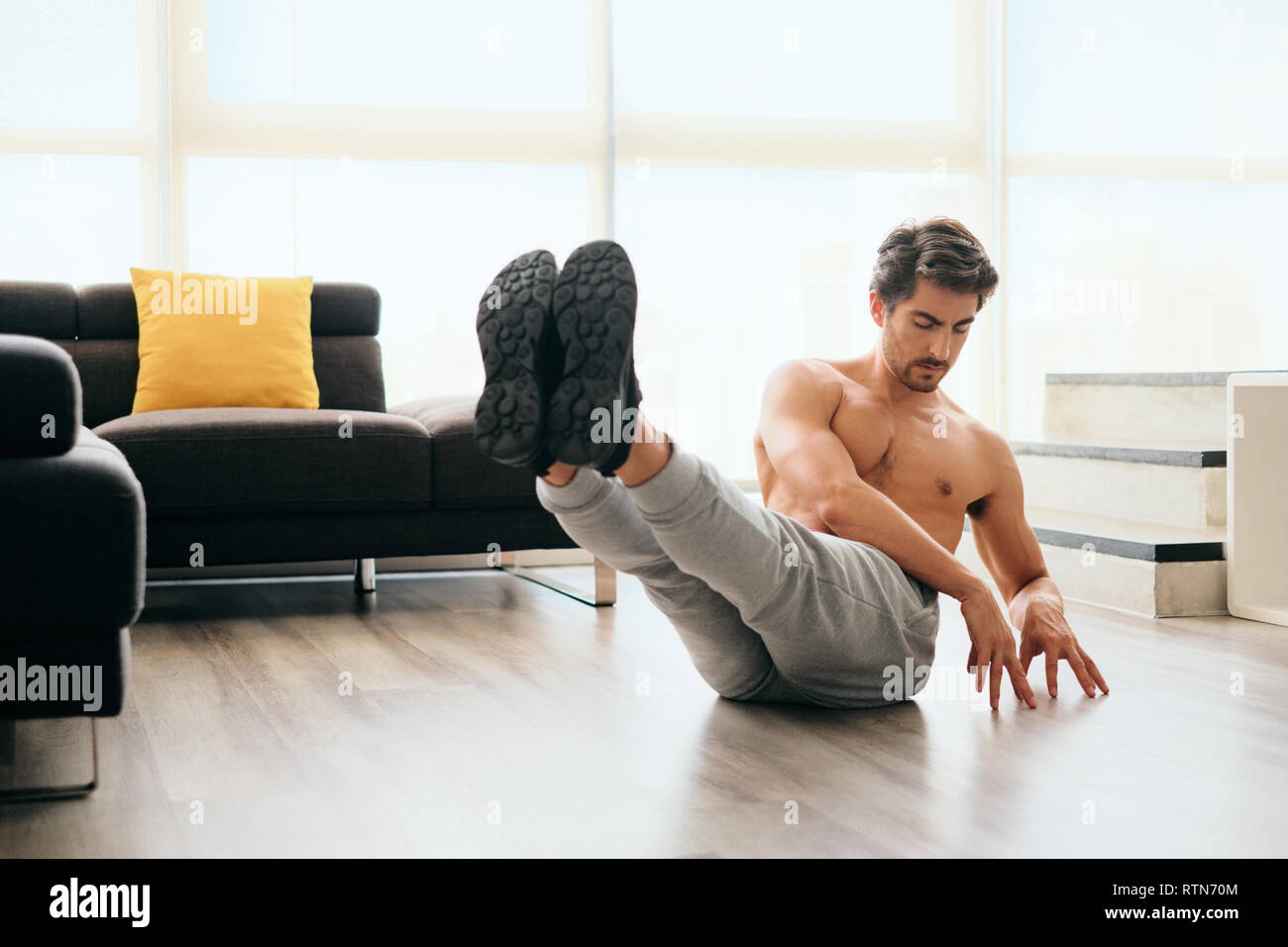 Fit young white man training at home. Handsome hispanic male athlete ...