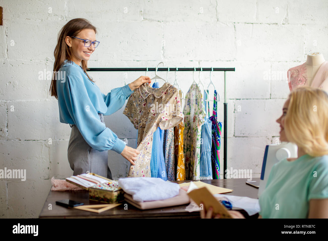 Female dressmaker is communicating with the potential client about ...