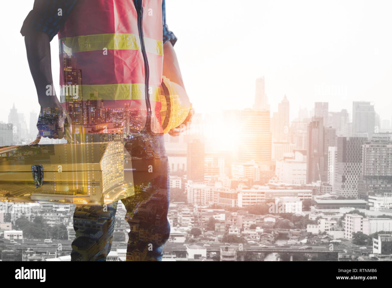 construction worker holding tool box with city background Stock Photo ...
