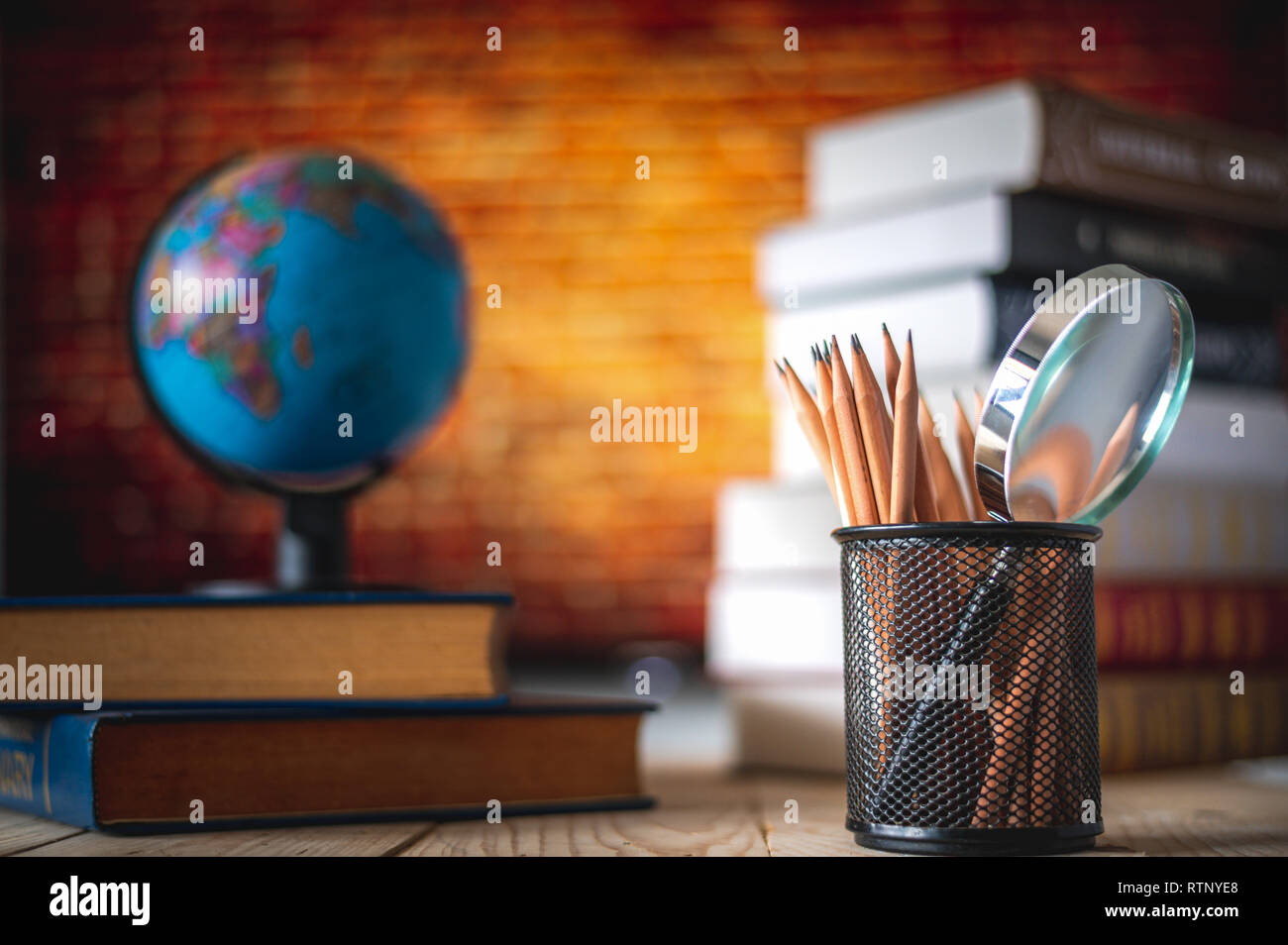 Textbooks, globe and pencils on a wooden background. Educational ...