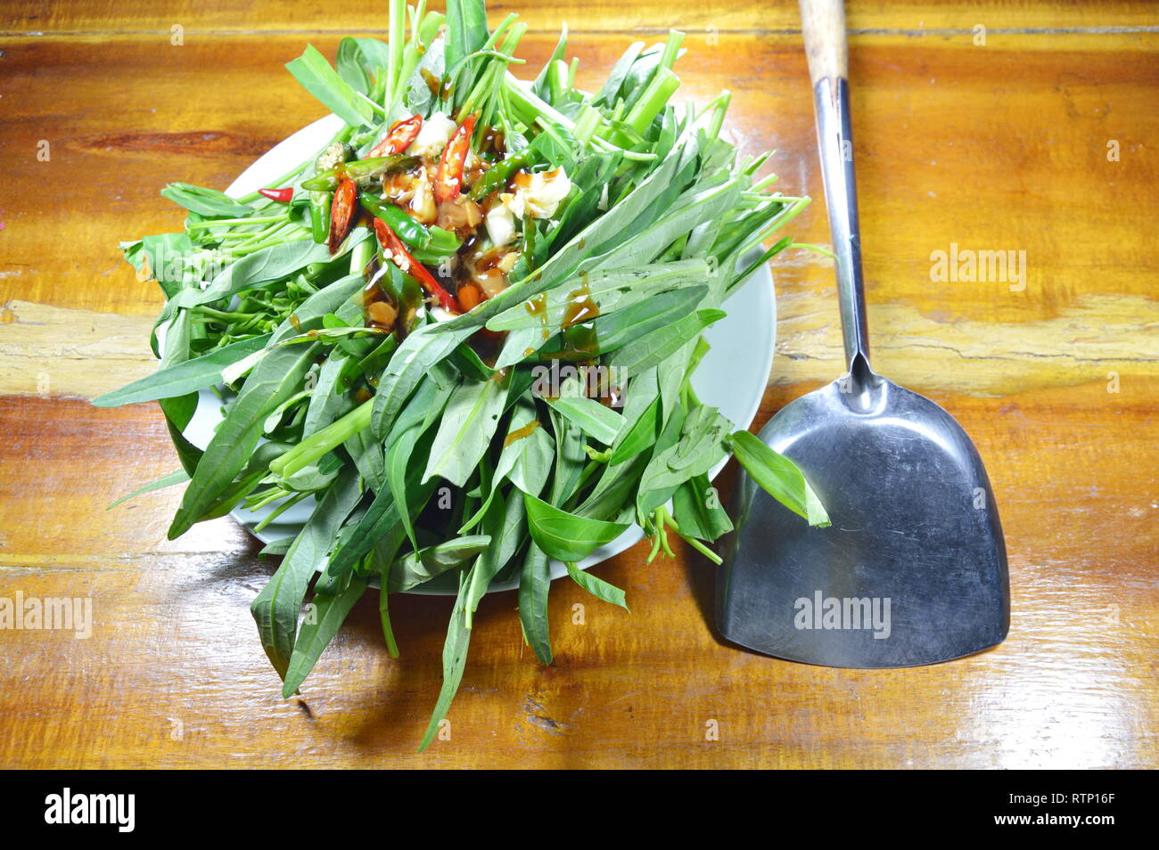 morning glory dressing sauce and iron flipper prepare to cook Stock ...