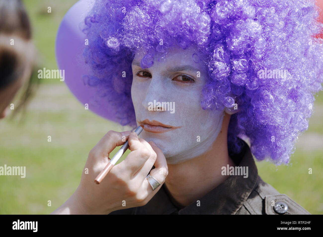 Makeup artist making clown face painting to the actor Stock Photo - Alamy