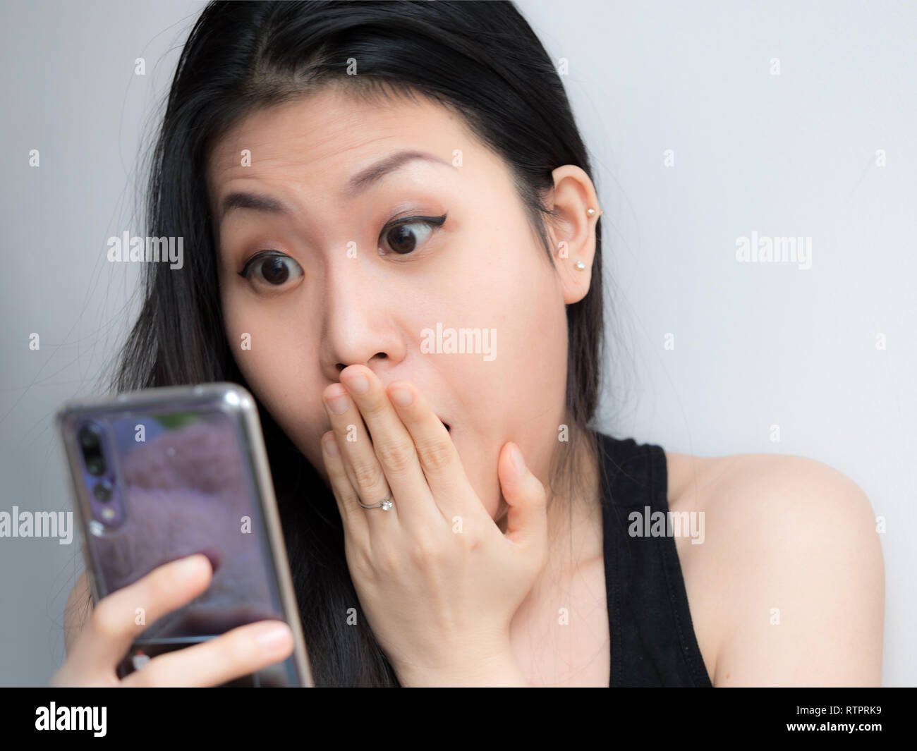 Excited Young Asian Beautiful Woman Amazed By Unbelievable Shopping