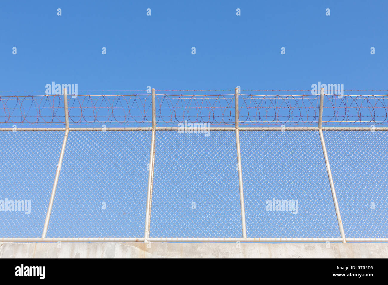 Security with a barbed wire fence Stock Photo - Alamy