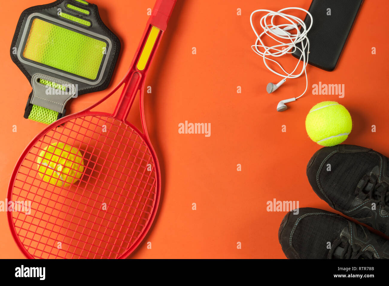 tennis set with tennis racket and smartphone on red background Stock ...