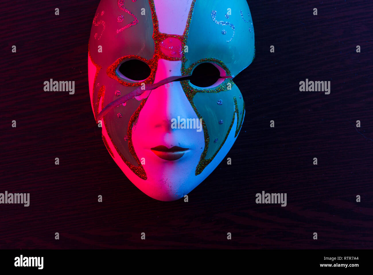 White mask on the dark wall in red light Stock Photo - Alamy