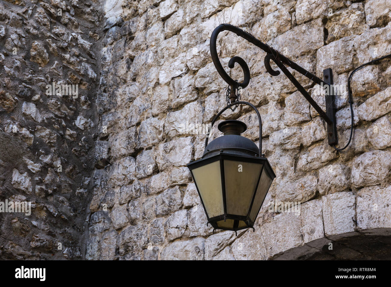 Old street lamp on the stone wall Stock Photo - Alamy