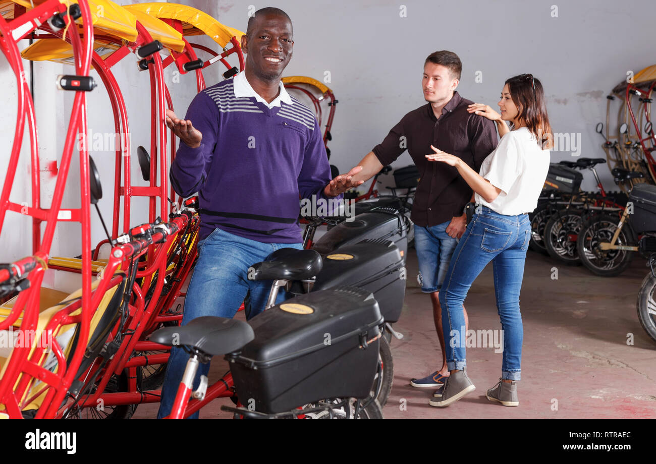 Portrait of smiling African-American man offering cycle rickshaw ...