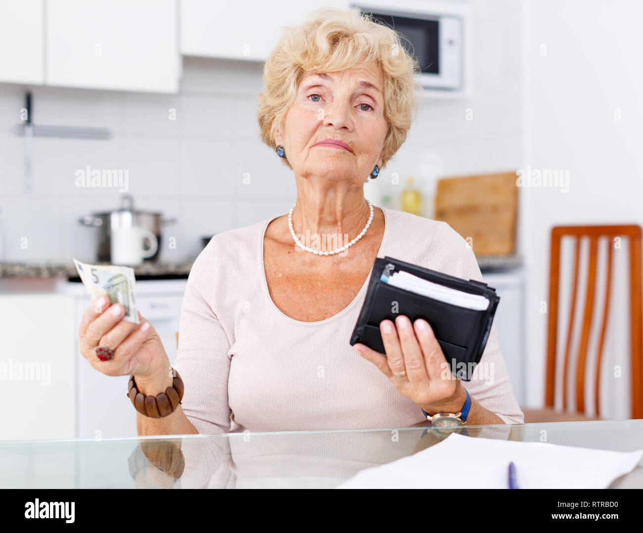 Senior woman is upset because of she has little money Stock Photo - Alamy