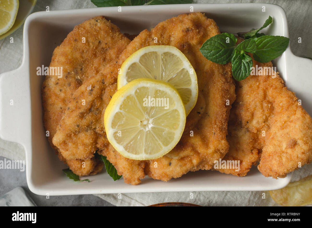 Delish breaded meat with steak house french fries Stock Photo - Alamy