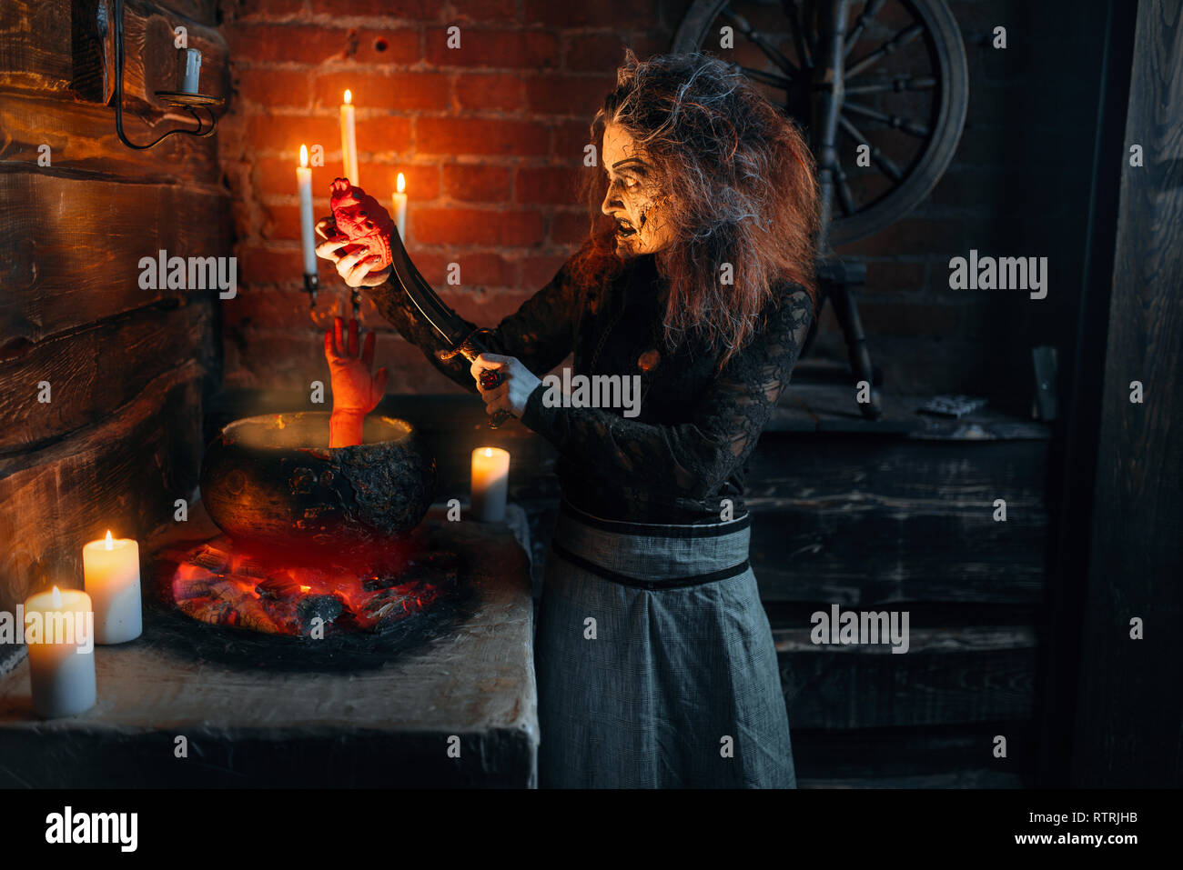 Scary witch cooking soup with human body parts, dark powers of ...