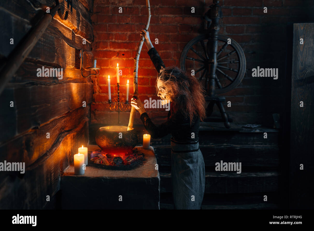 Scary witch cooking soup and reads spell, dark powers of witchcraft ...