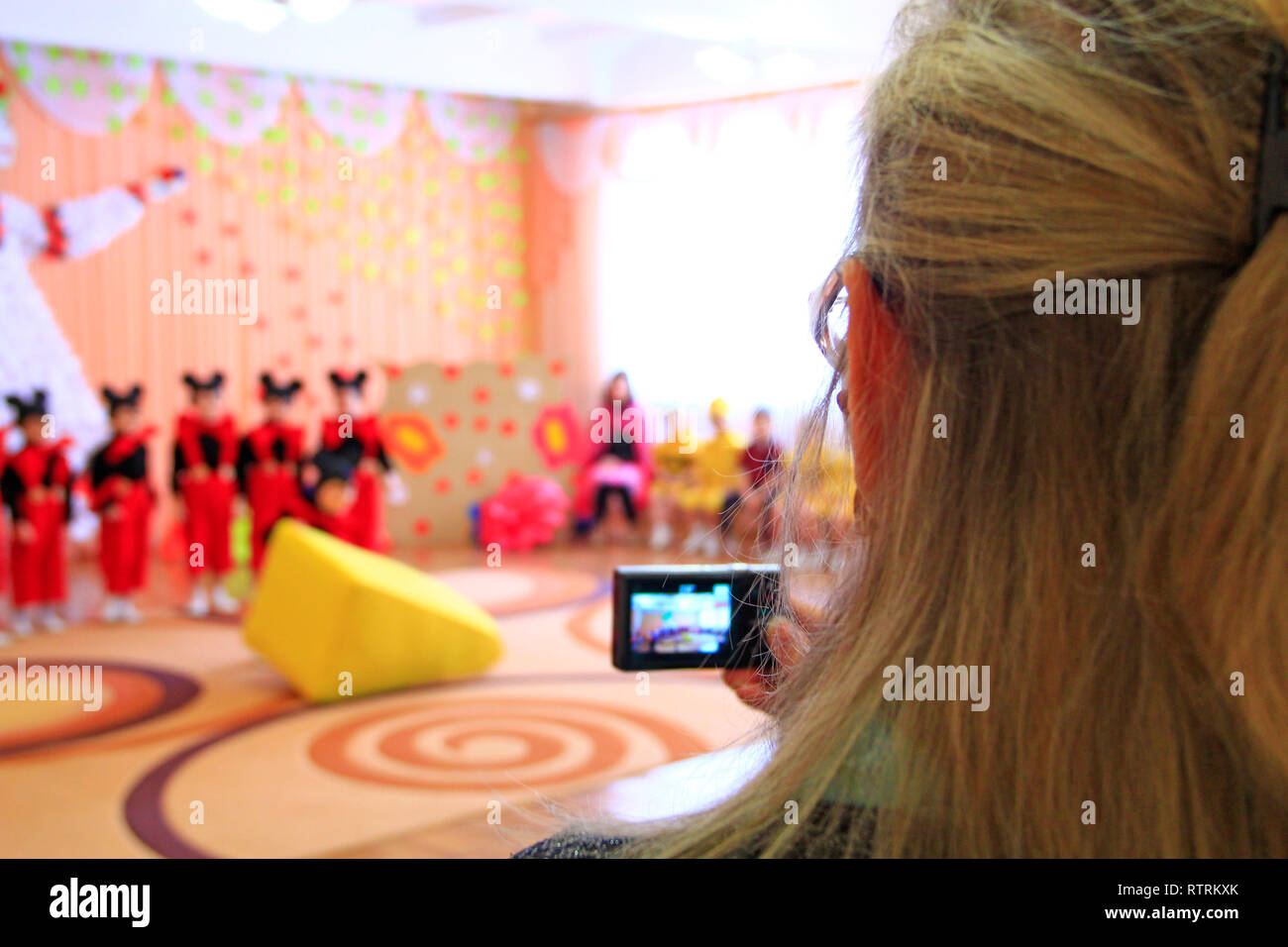 Woman takes pictures of children's morning party. Children in smart ...