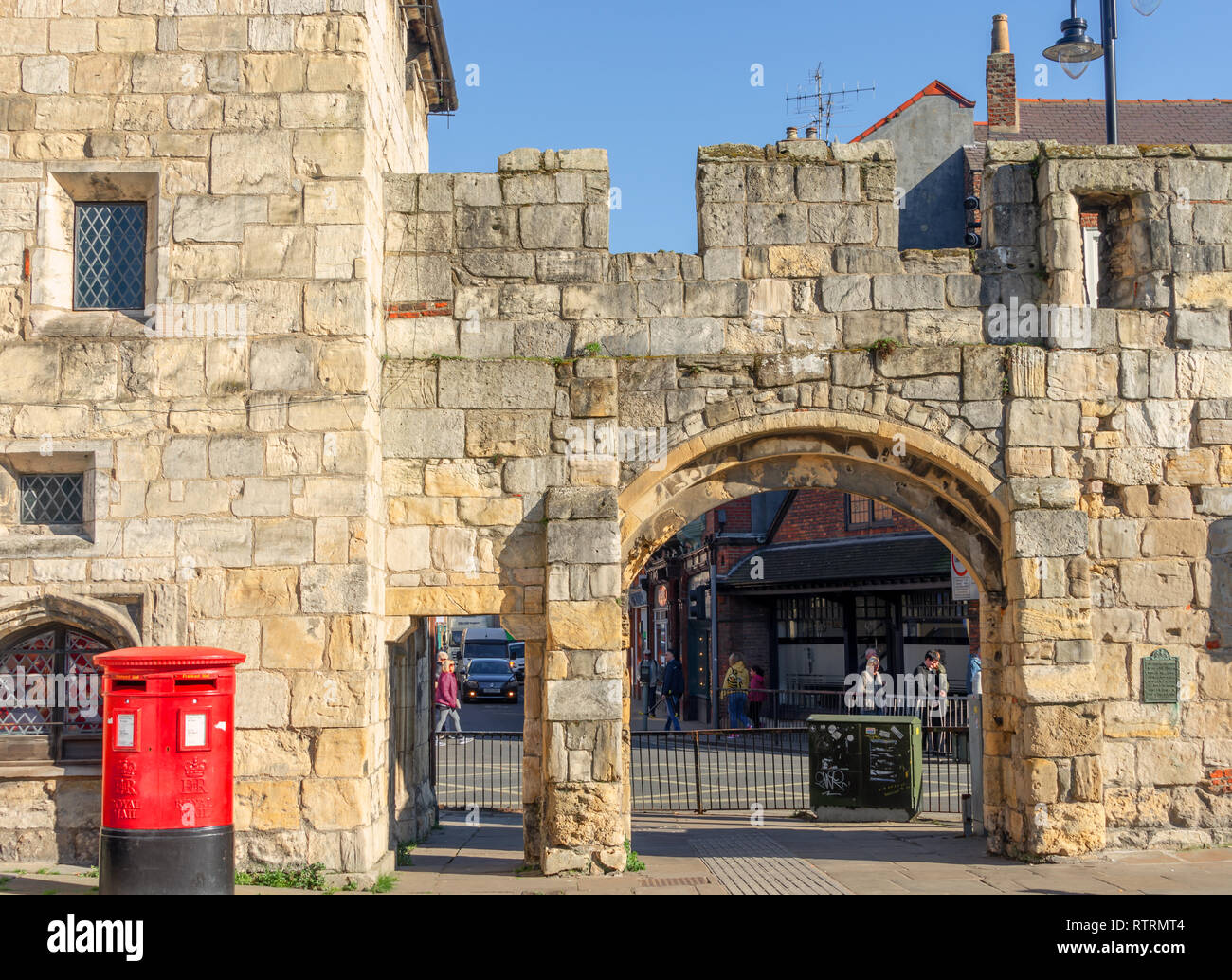 A section of the old city wall in York with an arched gateway. A ...
