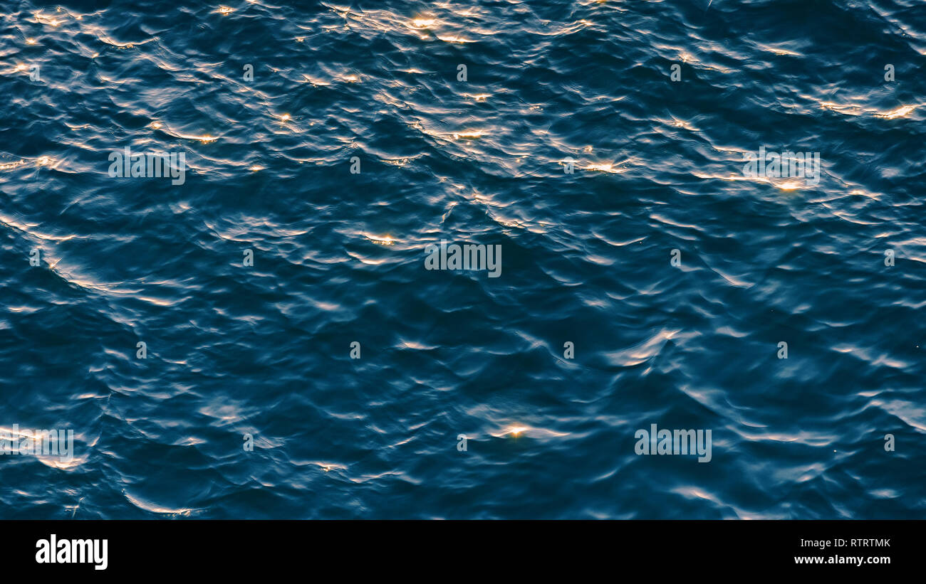 Glistening and shimmering blue ocean surface background with sun ...