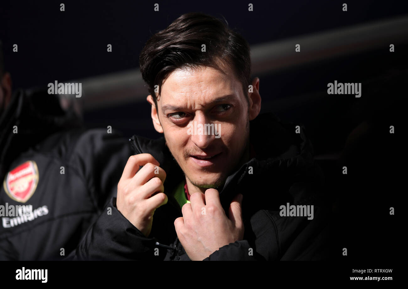 Arsenal's Mesut Ozil takes his place on the bench before the Premier ...