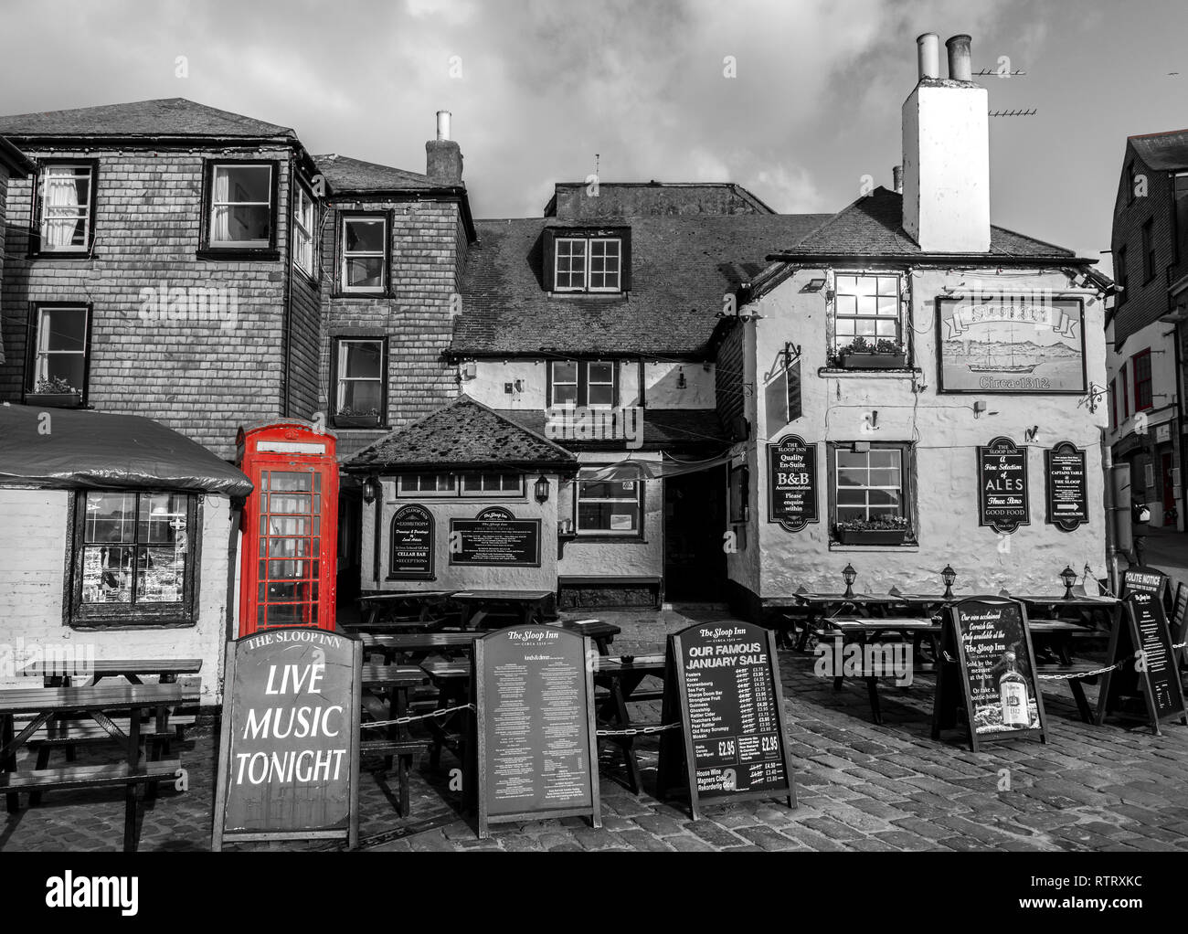 The famous Sloop Inn St.ives in Black and White with red telephone box ...