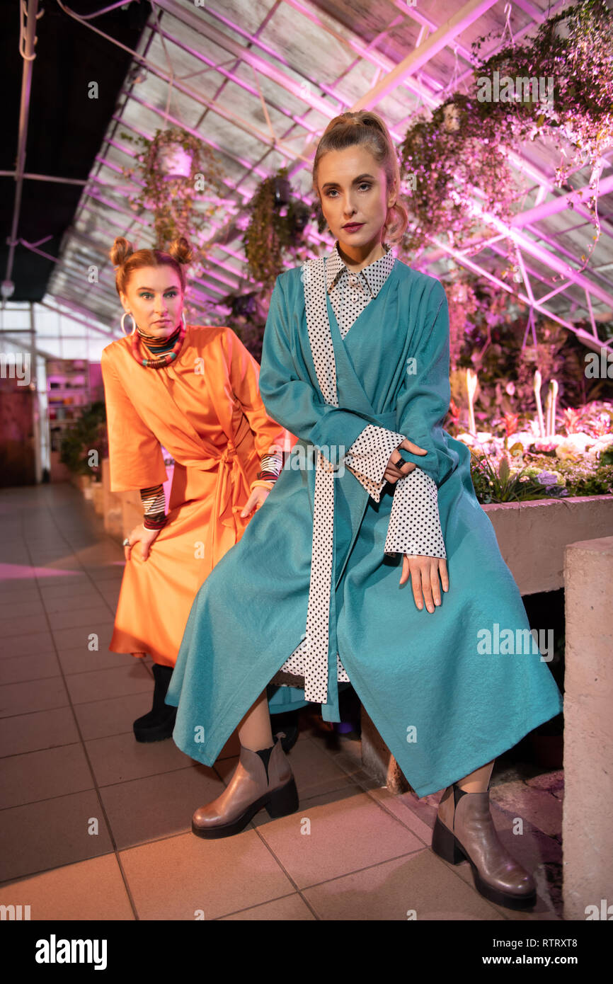 Attractive pleasant women standing together in the greenhouse Stock ...