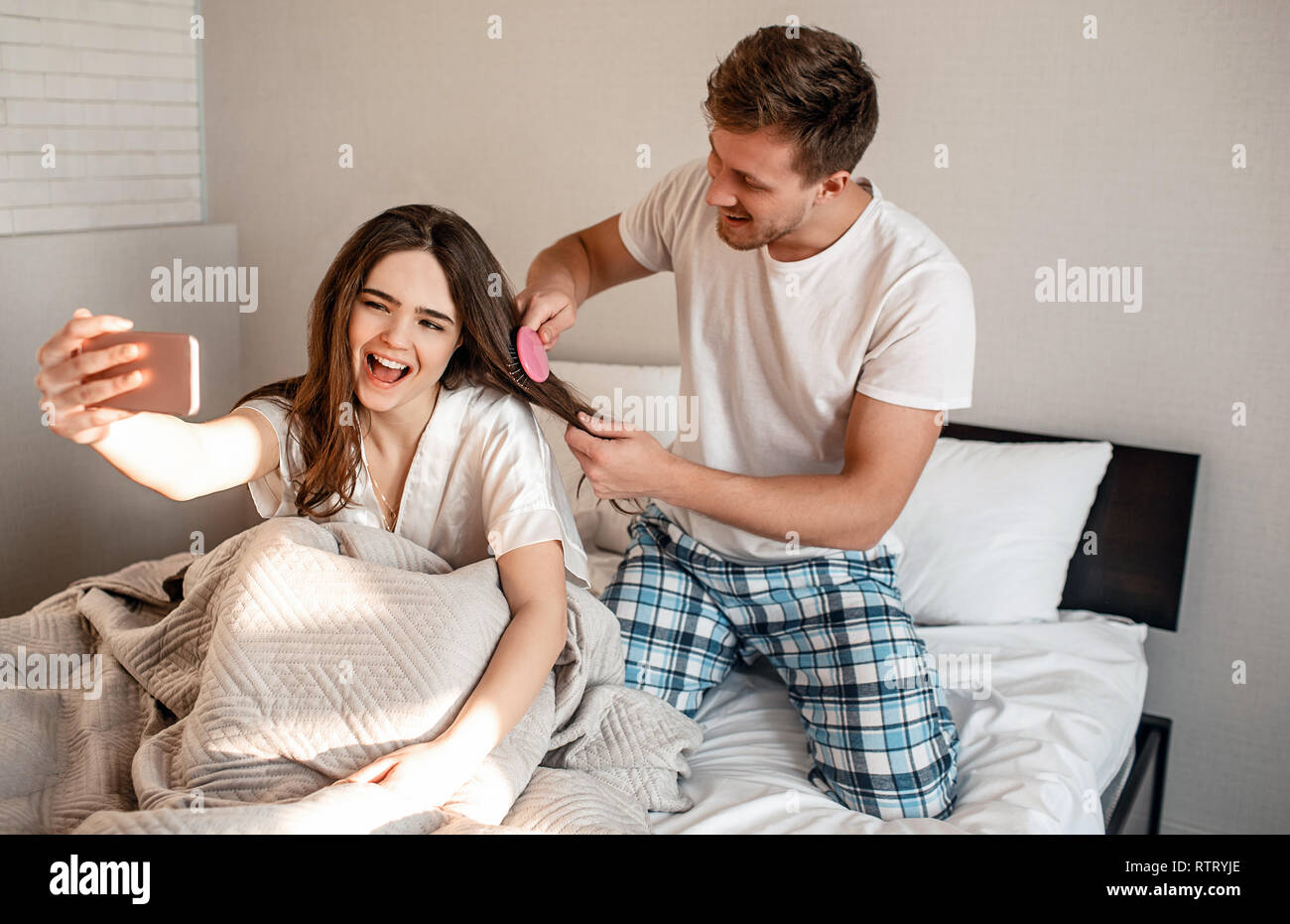 Young couple in the bed after waking up. Smiling beautiful man and ...
