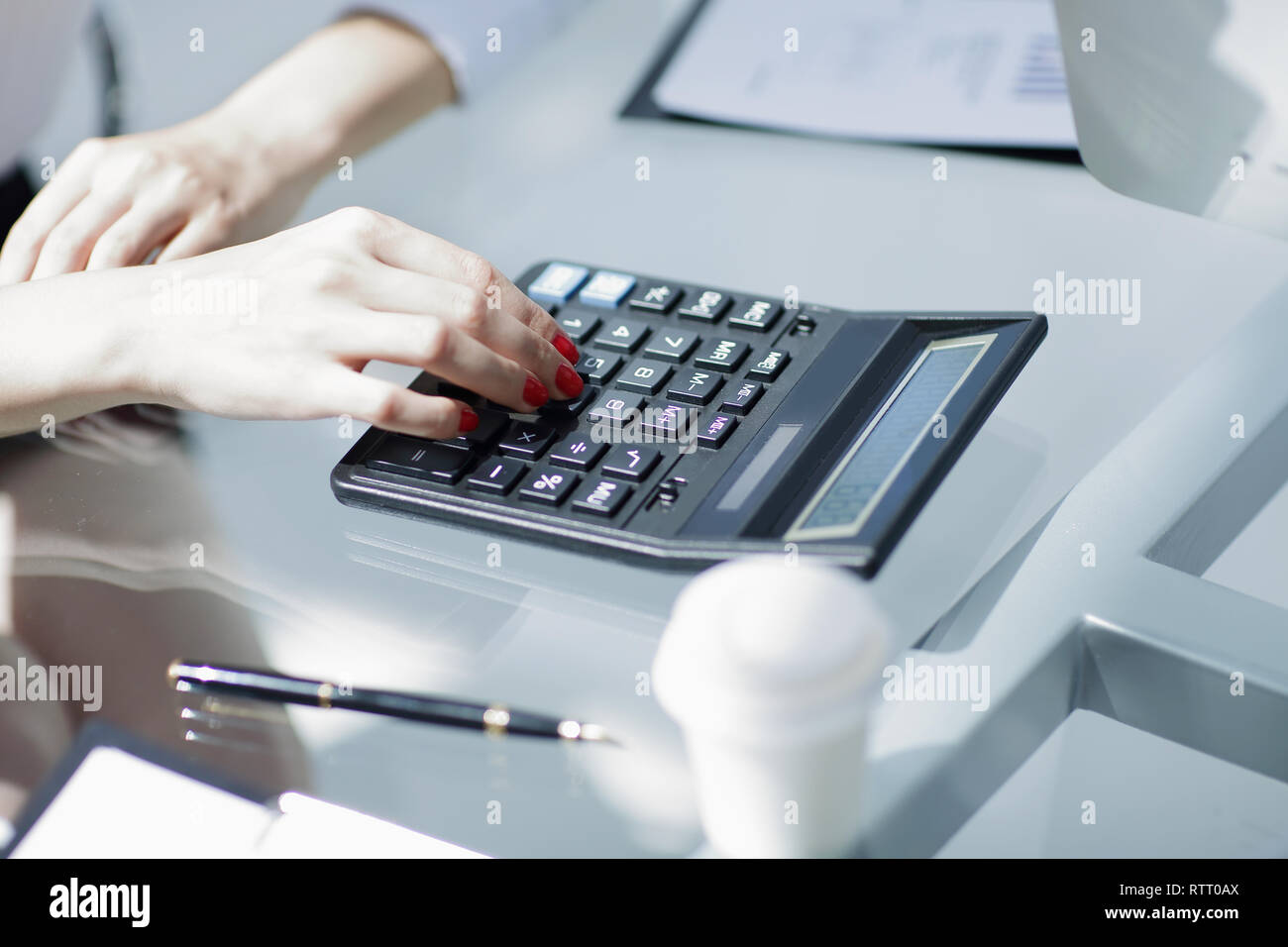 .closeup.business woman using a calculator at the workplace Stock Photo ...