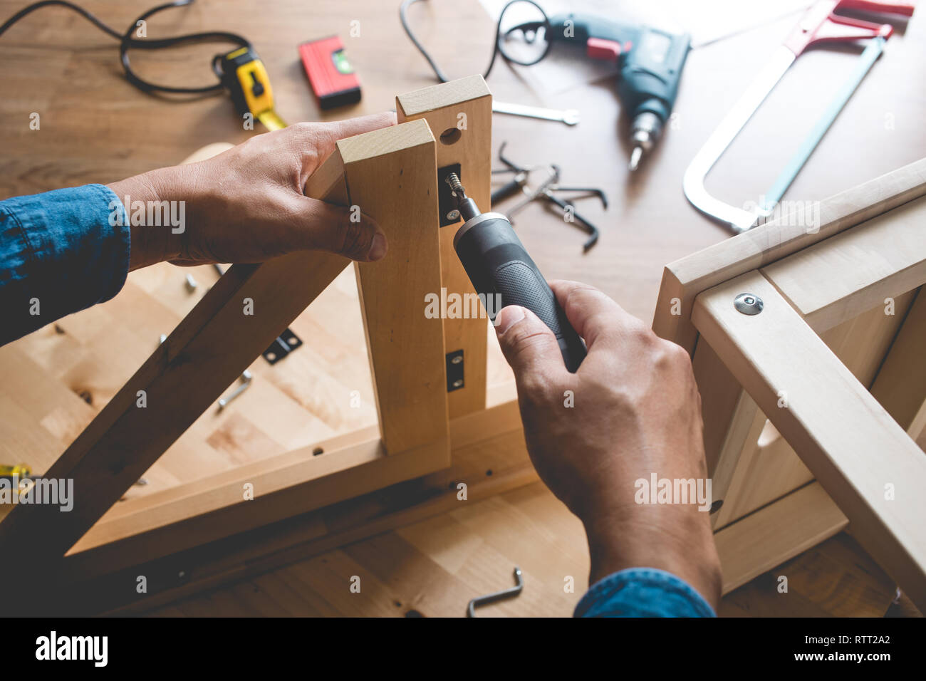 Man assembly wooden furniture,fixing or repairing house with ...