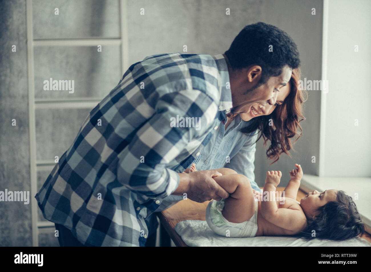 happy couple singing songs to their adorable little kid, close up side ...