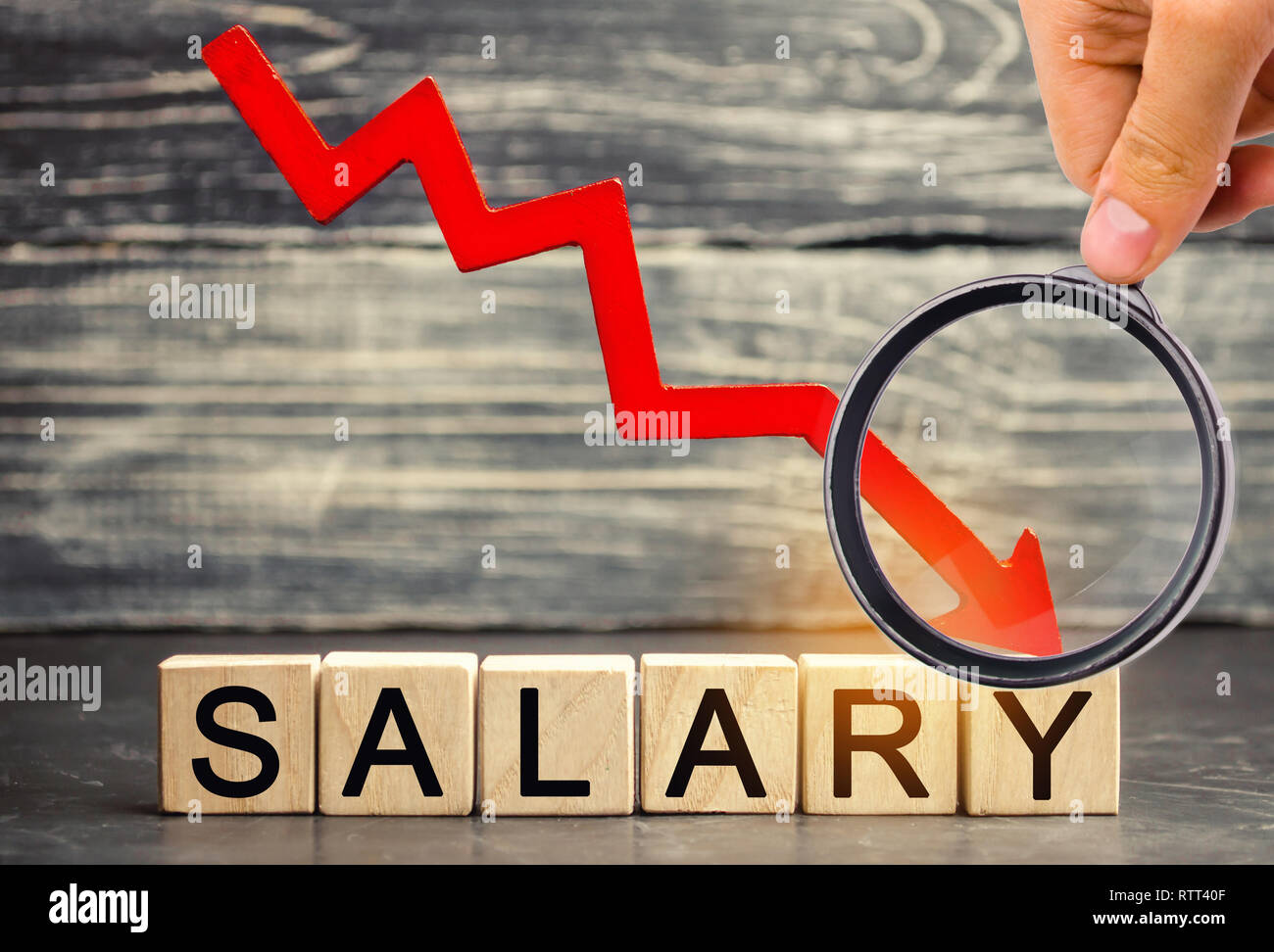 The inscription salary and the red arrow down. lower salary, wage rates ...
