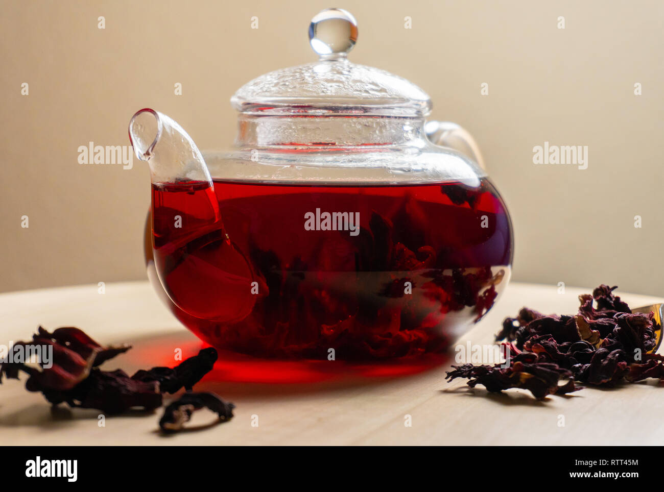 Red hibiscus tea in glass transparent teapot at wooden table Stock ...